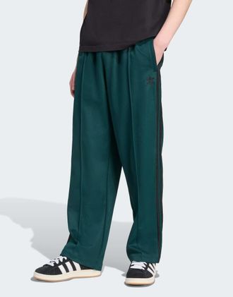 adidas Originals Firebird - Weite Trainingshose in Gr&uuml;n und Schwarz