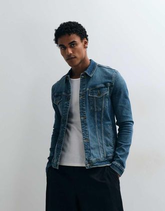 Asos veste en jean skinny style trucker bleu fonc&eacute; d&eacute;lav&eacute;
