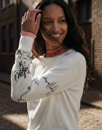 Desigual T-shirt en jersey avec inscription sur les manches - Blanc