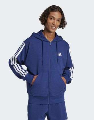 adidas Essentials - Kapuzenjacke aus French Terry in Dunkelblau / Weiß mit den drei Streifen