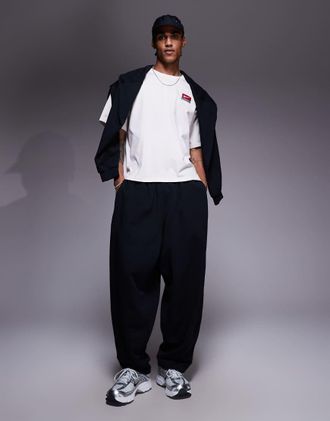 Nike Club - Pantalon de jogging oversize en tissu &eacute;ponge - Noir