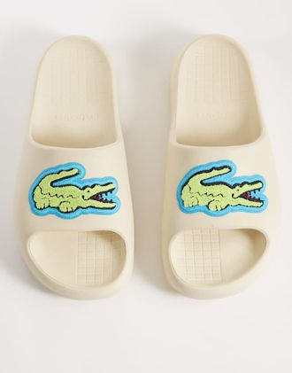 Lacoste Serve 2.0 - Claquettes &agrave; logo - Blanc cass&eacute;