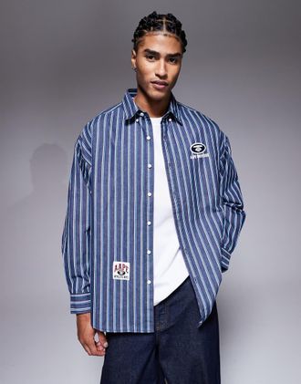 Aape By A Bathing Ape AAPE by A BATHING APE - Chemise oversize manches longues à rayures avec broderie au dos - Bleu marine
