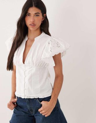 Gina Tricot Gina Tricot - Bluse aus reiner Baumwolle in Wei&szlig; mit Puff&auml;rmeln und Lochstickerei