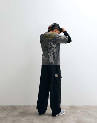 Aape By A Bathing Ape Aape by A Bathing Ape t-shirt oversize d&eacute;lav&eacute; charbon avec imprim&eacute; dos motocross-Noir