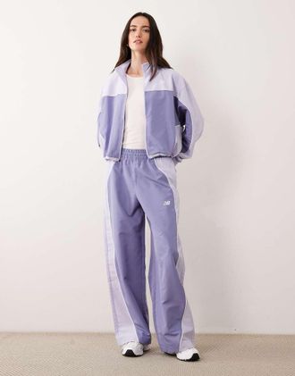 New Balance pantalon tiss&eacute; Trackside en violet fum&eacute; fonc&eacute;