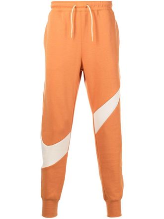 Nike pantalon de jogging en polaire à imprimé Swoosh - Orange