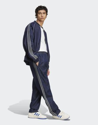 adidas Originals Adicolor - Pantalon de surv&ecirc;tement ample en denim - Indigo-Bleu