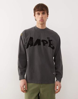 Aape By A Bathing Ape Aape by A Bathing Ape - Lang&auml;rmliges Oversize-T-Shirt in verwaschenem Schwarz mit Graffiti-Print