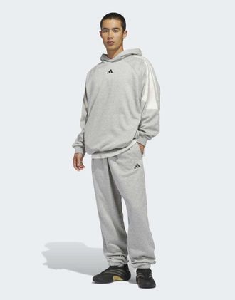 adidas adidas Performance - Pantalons de jogging unisexe en polaire style basketball - Gris chin&eacute; moyen