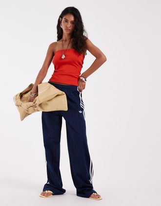 adidas Originals Firebird - Pantalon de surv&ecirc;tement ample &agrave; fines rayures - Bleu marine