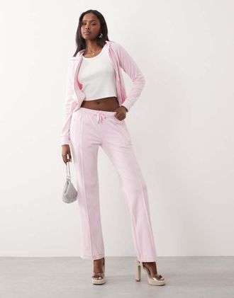 Juicy Couture Weit geschnittene Velours-Jogginghose in Babyrosa mit niedrigem Bund und Strass-Logo, Kombiteil