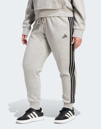 adidas adidas Performance - Essentials - Schmal geschnittene Hose (Plus-Size) in mittlerem Heidegrau/Schwarz mit den 3 Streifen