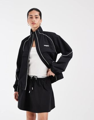 Tommy Jeans Trainingsjacke in Schwarz mit Paspelierung, Kombiteil