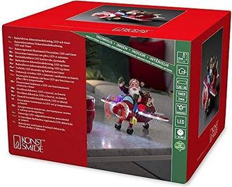 Konstsmide LED Szenerie Weihnachtsmann im Flugzeug, mit Animation, Geräuschsensor und 2 min Timer, 8 kalt weiße Dioden, batteriebetrieben, Innen - 4200-000