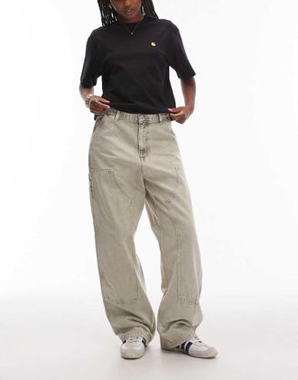 Carhartt Work in Progress Brandon - Lockere Jeans in verwaschenem Kreidegrau mit Details an beiden Knien