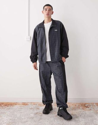 XLARGE XLarge - Pantalon de survêtement densemble color block à carreaux avec chevilles resserrées - Noir