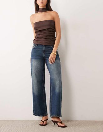Juicy Couture Jeans in blauer Vintage-Waschung mit weitem Bein, mittelhohem Bund und Wappen-Logostickerei