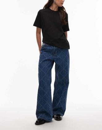 Calvin Klein Jeans Jean baggy taille basse &agrave; logo r&eacute;p&eacute;t&eacute; avec d&eacute;coupes laser - Bleu moyen