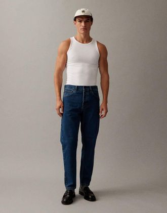 Carhartt Work in Progress Newel Jeans mit Relaxed Tapered Fit in mittlerer Waschung-Blau