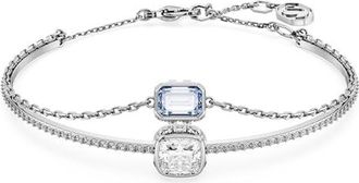 Swarovski Bracelet-jonc Stilla composé dun anneau rigide, dune chaîne souple et ornés de cristaux incolores et dune pierre bleue, en métal rhodié