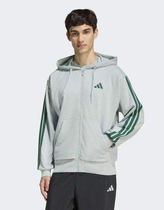 adidas adidas Performance - Essentials - Kapuzenjacke aus French Terry in Wonder Sage/College-Gr&uuml;n mit durchgehendem Rei&szlig;verschluss und den 3 Streifen